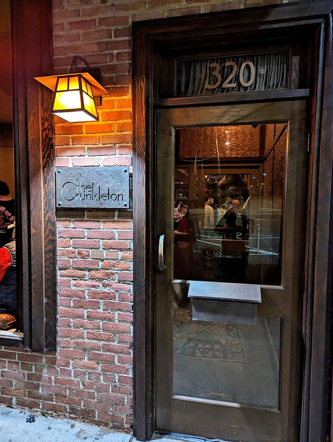 Behind this unassuming brick exterior lies cocktail magic. The Crunkleton's warm ambiance invites you to linger longer.