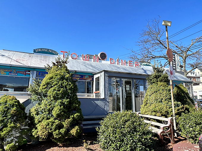 Sunlight catches the vintage sign of this Watertown landmark, where pancake flipping is considered an Olympic-worthy sport.