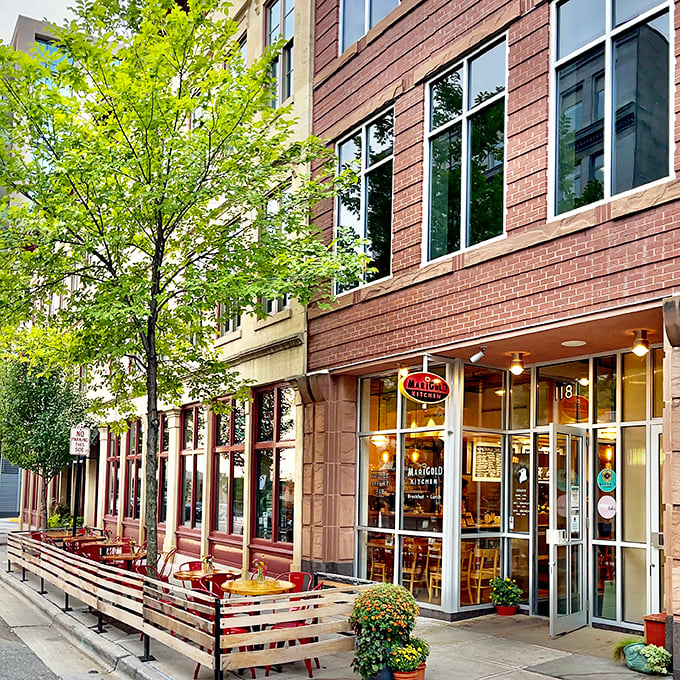 Bright windows and brick walls frame The Marigold Kitchen, where modern breakfast sensibilities meet timeless comfort food satisfaction.