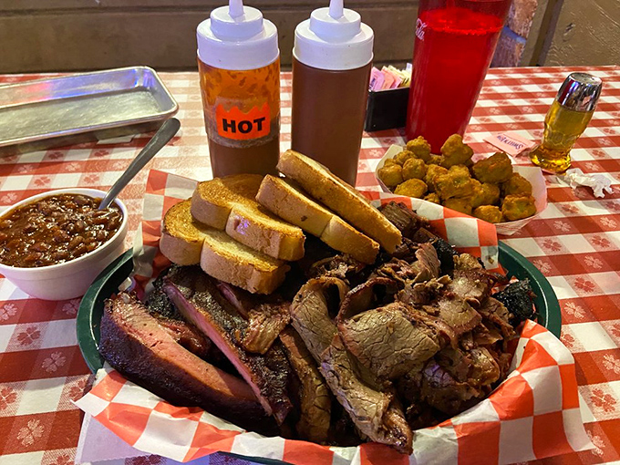 This isn't just a platter&mdash;it's a carnivore's dream state. Multiple meats, sauce bottles standing by, and bread for impromptu sandwiching. Strategic eating at its finest.