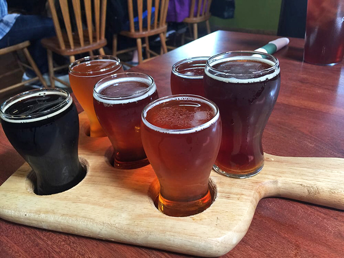 A wooden flight board showcasing liquid amber treasures&mdash;proof that beer sampling is actually a sophisticated art form.