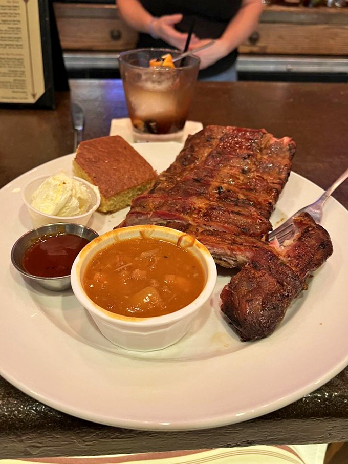 These ribs aren't just served &ndash; they're presented with the reverence they deserve, alongside house-made BBQ sauce that enhances rather than masks.