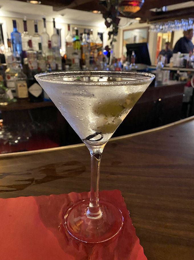 A perfectly chilled martini with olives standing at attention&mdash;the ideal companion while deciding between ribeye and filet.