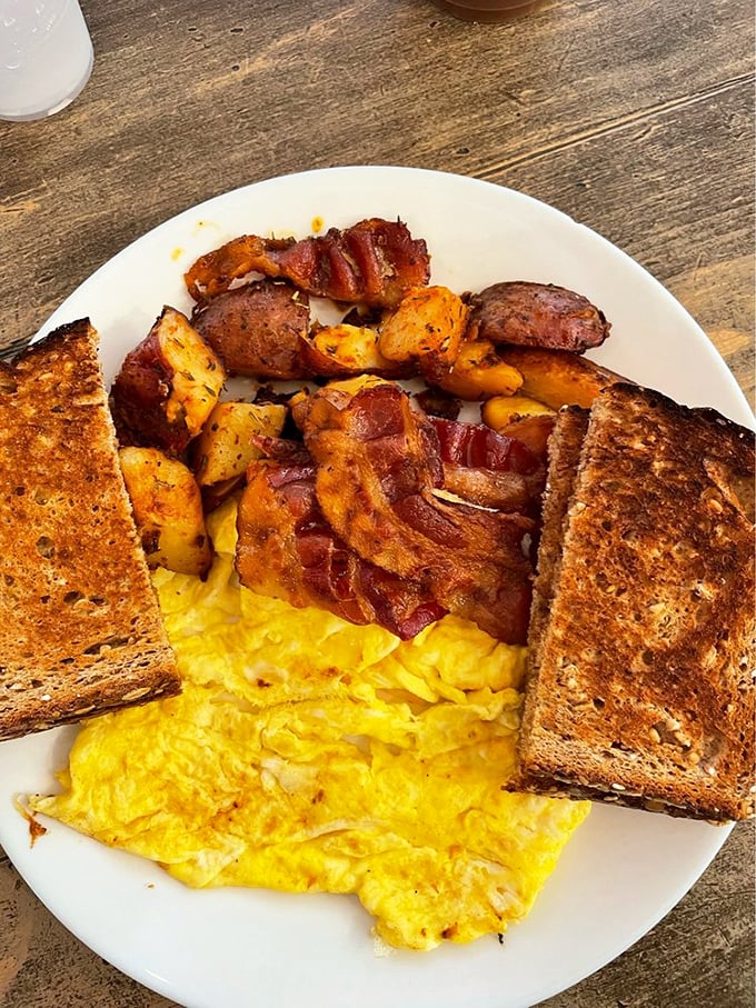 The breakfast trinity: golden eggs, crispy bacon, and toast that actually received attention rather than afterthought status. 