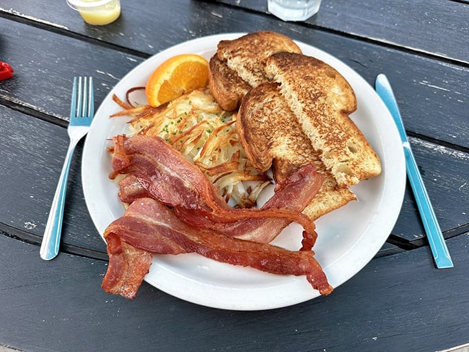 Start your day right with a classic breakfast platter featuring crispy bacon, golden hash browns, and perfectly toasted bread.