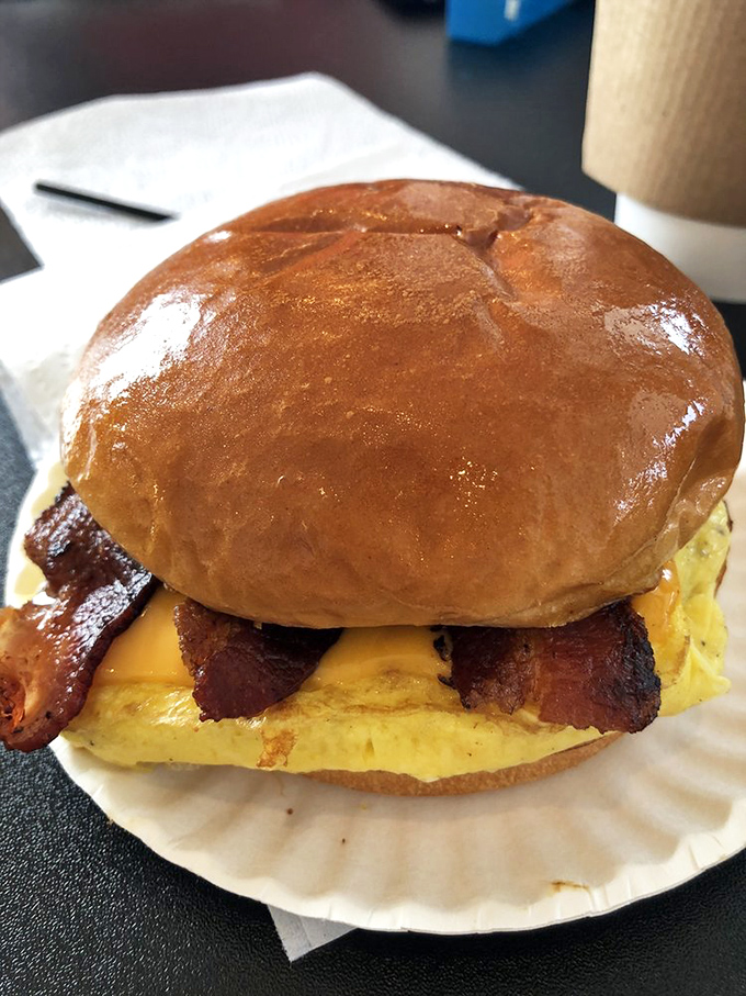 Breakfast sandwich architecture that deserves its own HGTV show&mdash;that glossy bun roof supported by pillars of bacon and egg.