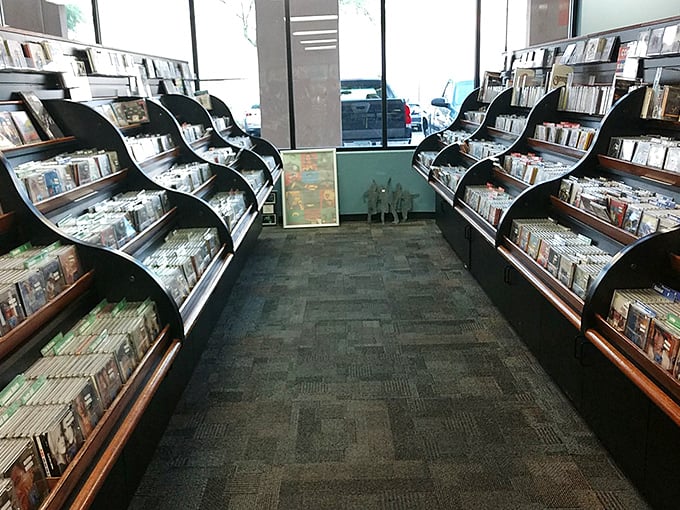 CD aisles designed for the joy of physical browsing&mdash;something streaming services can never replicate. Those curved displays invite tactile exploration.