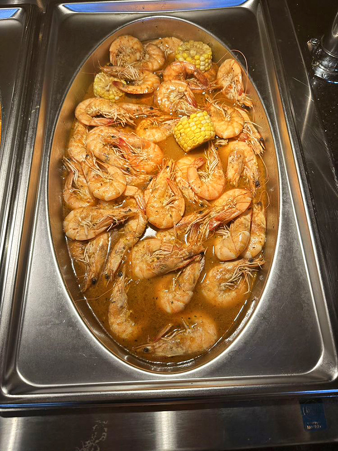 Shrimp swimming in savory sauce with corn on the cob lifeguards standing by. The kind of dish that makes you consider drinking the broth.