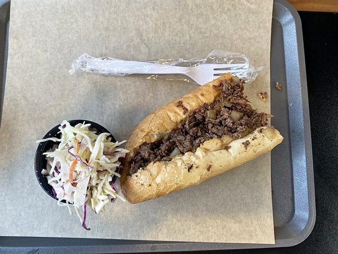 A proper cheesesteak with a side of fresh coleslaw—the kind of honest lunch that fueled America's cross-country adventures for generations.