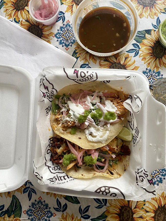 Taco architecture at its finest—each ingredient layered for maximum flavor impact, with those pink pickled onions adding the perfect finishing touch.