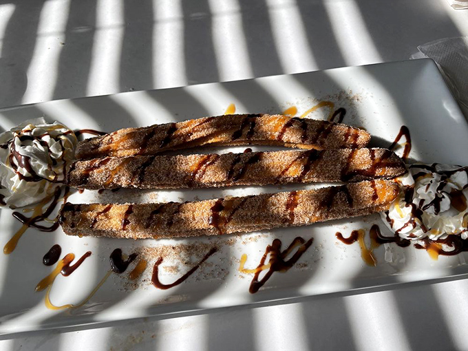 Churros drizzled with chocolate and caramel&mdash;proof that happiness can be fried, dusted with cinnamon sugar, and served on a plate.