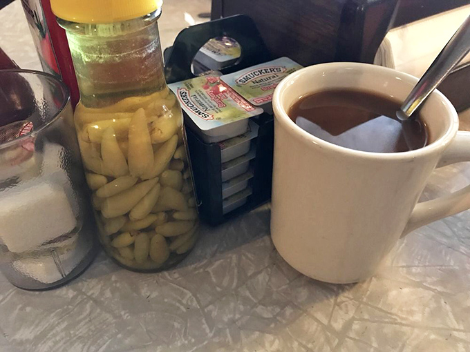 Coffee in honest ceramic mugs, with pickled garnish on standby&mdash;a morning ritual elevated to an art form.