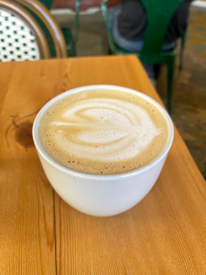 A perfect leaf pattern emerges from the golden crema&mdash;evidence that someone behind the counter cares deeply about your morning ritual.