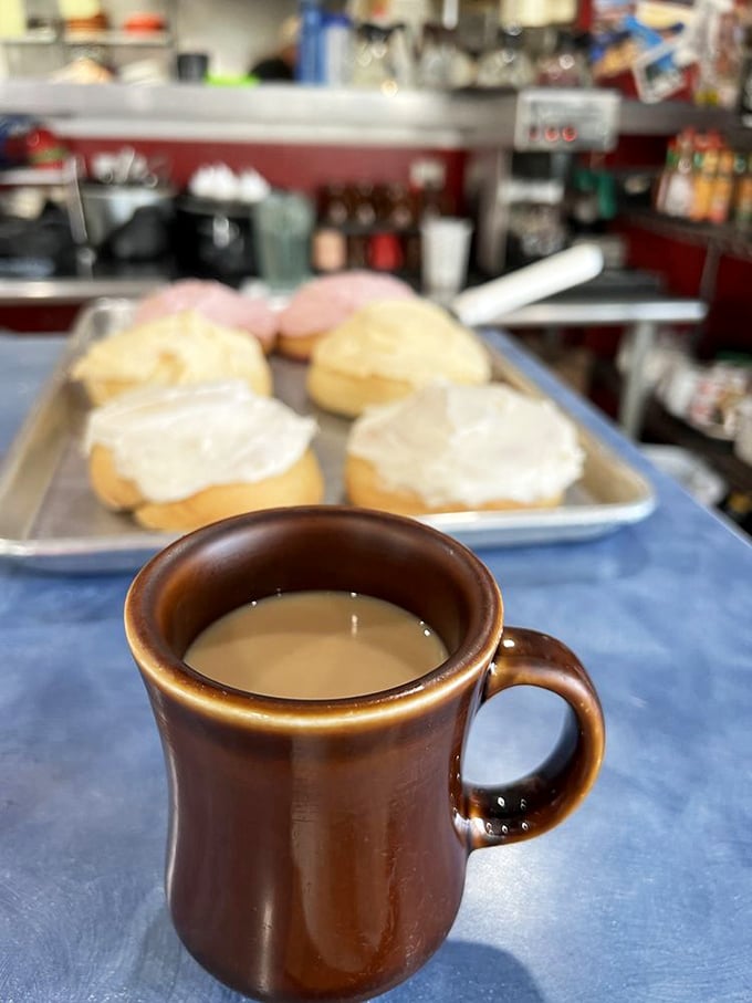 That perfect diner coffee moment&mdash;brown ceramic mug, fresh pastries in the background. Some mornings need nothing more.