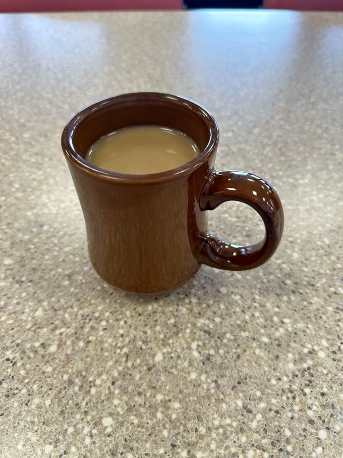 Ah, the elixir of life in its natural habitat. This isn't just coffee; it's liquid motivation, served in a mug that's seen more stories than a Vegas blackjack dealer.