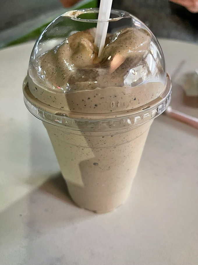The milkshake that launched a thousand road trips. Speckled with cookie pieces and thick enough to require serious straw strength. 