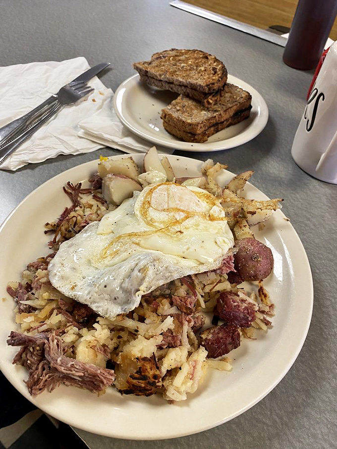 When breakfast demands serious attention, corned beef hash topped with sunny-side-up eggs answers the call. The kind of plate that makes morning people out of night owls.