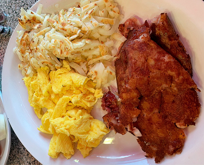 Breakfast of champions: golden eggs beside crispy corned beef hash&mdash;proof that morning meals can indeed be the highlight of your day.