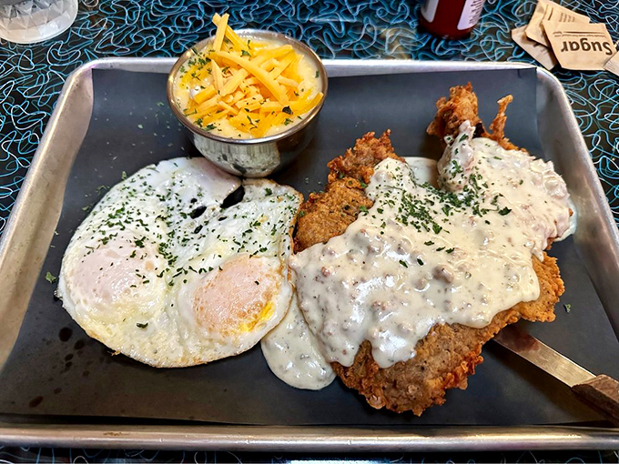 Country fried steak smothered in gravy with a sunny-side-up egg&mdash;breakfast, lunch, and dinner having a party on one magnificent plate.