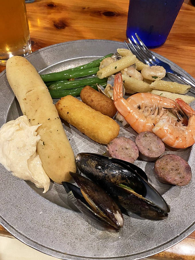 Ocean meets garden in this plate of steamed mussels, sausage, and green beans &ndash; proof that balance exists even at a buffet.