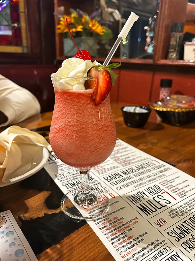 Strawberry daiquiri dressed for success with whipped cream, cherry, and fresh fruit. Vacation in a glass, even if you're just vacationing from Tuesday.