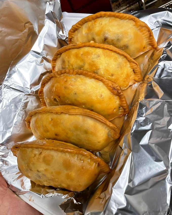 Golden empanadas lined up like edible treasures. Crispy on the outside, steamy and flavorful inside&mdash;the Fort Knox of hand-held delights.