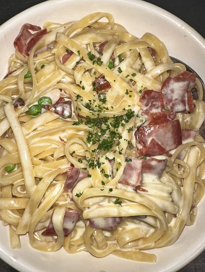 Carbonara that whispers "I've got you" with each creamy, bacon-studded bite&mdash;comfort food operating at its highest diplomatic level.