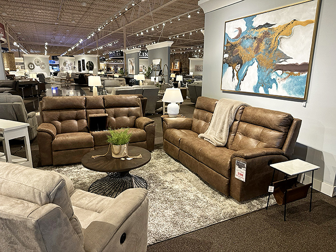 Leather sectionals arranged like a living room oasis. The kind of seating that makes you cancel plans just to stay home.