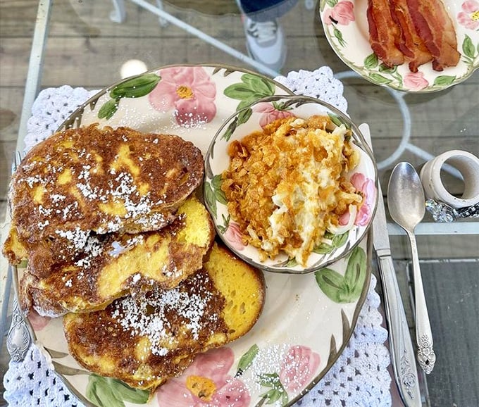 Golden French toast dusted with powdered sugar alongside creamy hash browns&mdash;breakfast that makes you understand why it's the most important meal.