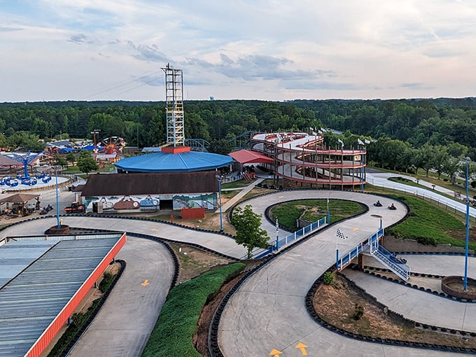 The aerial view reveals the park's thoughtful layout &ndash; curving go-kart tracks wind through greenery, promising competitive thrills for speed demons of all ages.