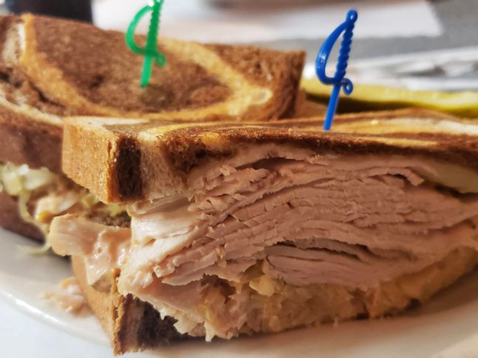 This turkey sandwich isn't just stacked&mdash;it's architectural. Those colorful toothpicks aren't decoration; they're structural support.