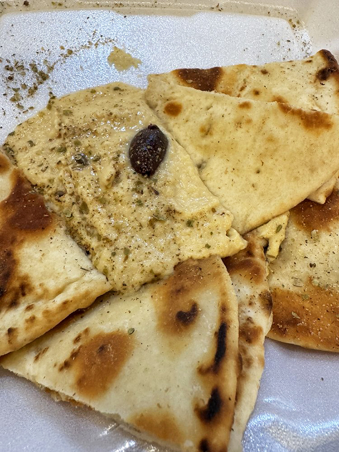 Pita triangles surrounding hummus like worshippers at an altar. The char marks are like flavor freckles&mdash;beautiful imperfections that add character.