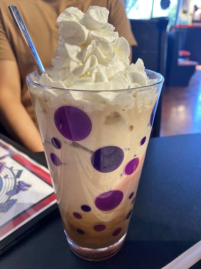 That isn't just a milkshake – it's a polka-dotted tower of creamy delight, topped with enough whipped cream to make a cloud jealous.