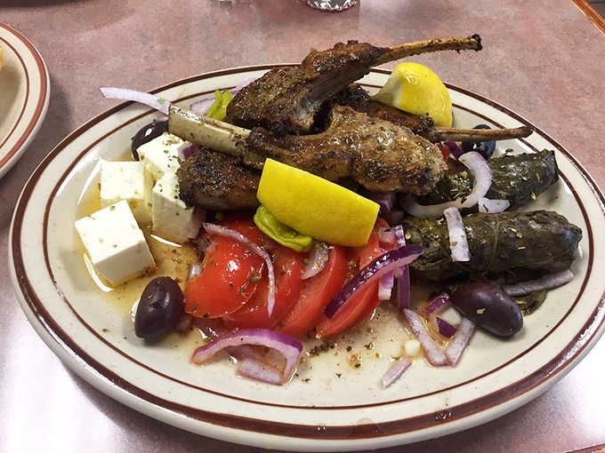 Lamb skewers lounging on a Greek salad like they own the place. The olives and feta are practically having a Mediterranean reunion.