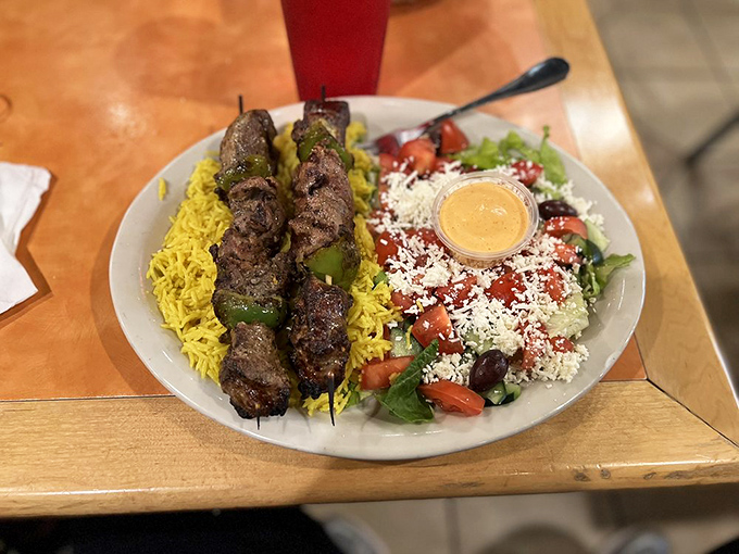 Lamb kebabs that could make vegetarians question their life choices. Served alongside saffron rice and a Greek salad that's anything but an afterthought.