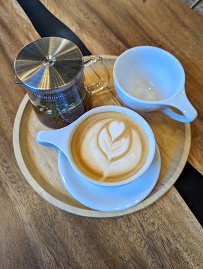 Two cups are better than one. The wooden table setting makes this coffee moment feel like you've stumbled into the world's coziest boardroom.
