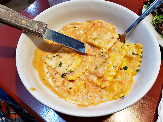 Lobster ravioli bathed in a blush sauce that's practically blushing with flavor. Each pillow of pasta holds a secret worth discovering.