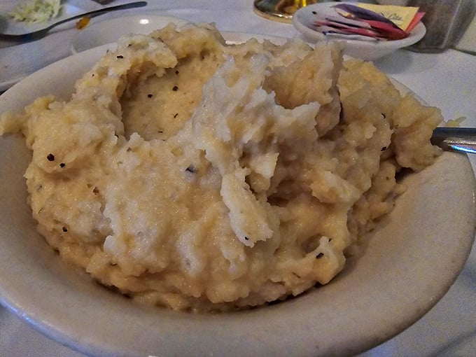 These mashed potatoes aren't just whipped, they're serenaded into submission &ndash; fluffy peaks waiting for gravy's warm embrace.