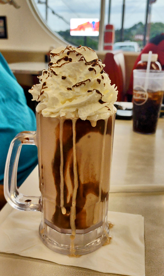 Not just a milkshake, but a skyscraper of dairy delight. This towering creation makes you wonder if straws were invented specifically for this moment.