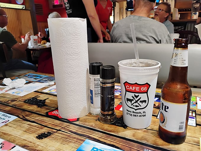 Tabletop still life with American classics: cold beer, paper napkins, and branded cups. Norman Rockwell would have ordered seconds.