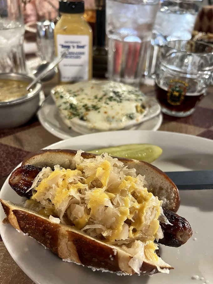 A proper German bratwurst nestled in a pretzel roll with sauerkraut is what happens when comfort food gets a PhD in deliciousness.
