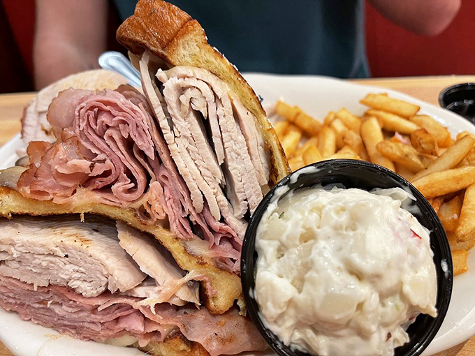 The sandwich that launched a thousand food comas&mdash;layers of deli meat stacked with architectural precision between perfectly grilled bread with creamy coleslaw standing guard.