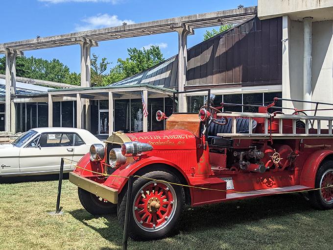 This gleaming vintage fire truck stands ready for action, its brass fittings and hand-polished surfaces a testament to an era when emergency vehicles doubled as civic pride.