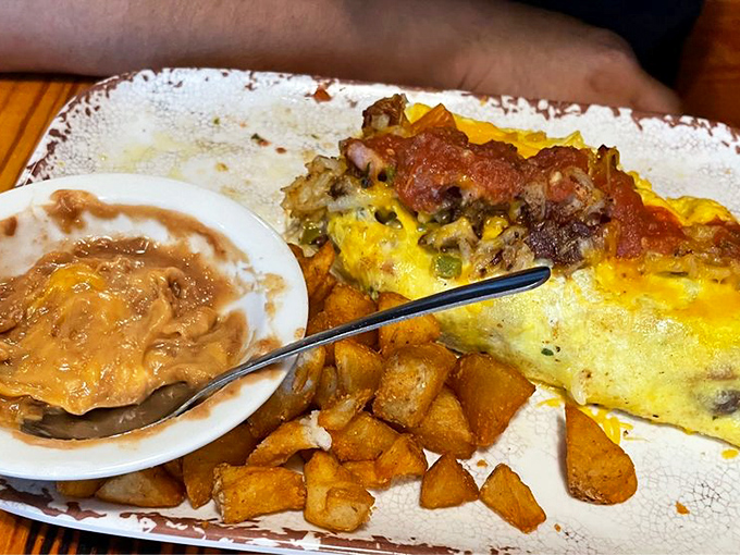 When an omelet meets Texas-sized ambition, this happens. Those country potatoes on the side aren't just a garnish&mdash;they're essential supporting actors.