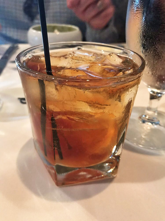 An old fashioned cocktail sits regally on white linen&mdash;amber liquid and ice in perfect harmony, waiting to complement whatever French delicacy comes next.