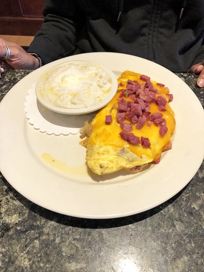 Southern comfort meets Maryland morning. That creamy bowl of grits alongside a ham-studded omelet is a cross-cultural breakfast masterpiece.
