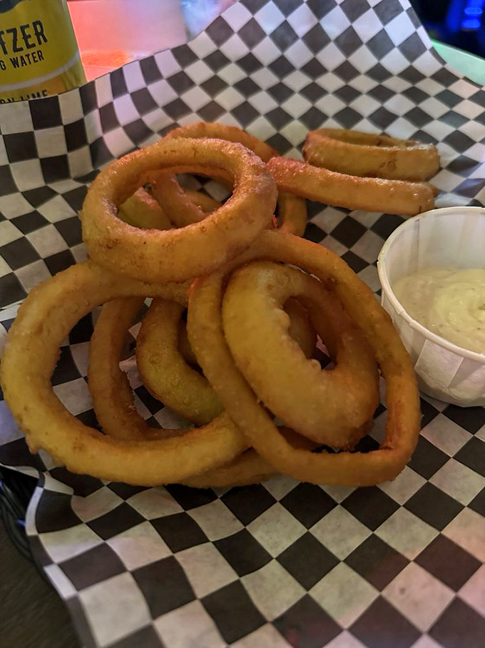 These aren't your average onion rings&mdash;they're golden halos of happiness, perfectly paired with creamy dipping sauce and cold beer.
