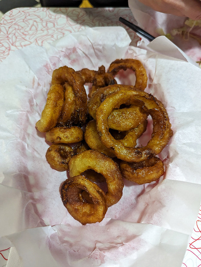 Golden halos of deep-fried perfection. These onion rings aren't just side dishes—they're the supporting actors who steal the show.