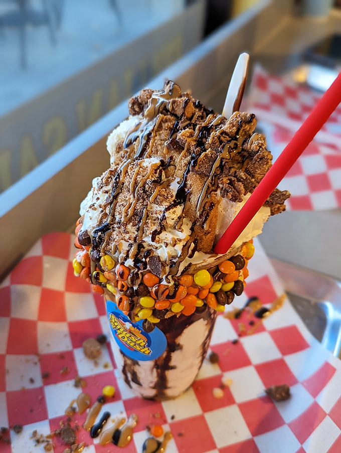 Dessert or architectural marvel? This shake defies both gravity and restraint, topped with enough goodies to qualify as its own food group.