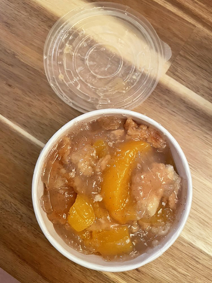 This isn't just peach cobbler – it's summer sunshine captured in a cup, with fruit so tender it surrenders at the mere suggestion of a spoon.